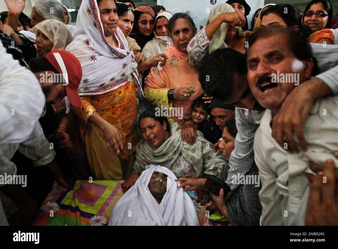 FILE - In this June 9, 2011 file photo, Family members mourn the death ...