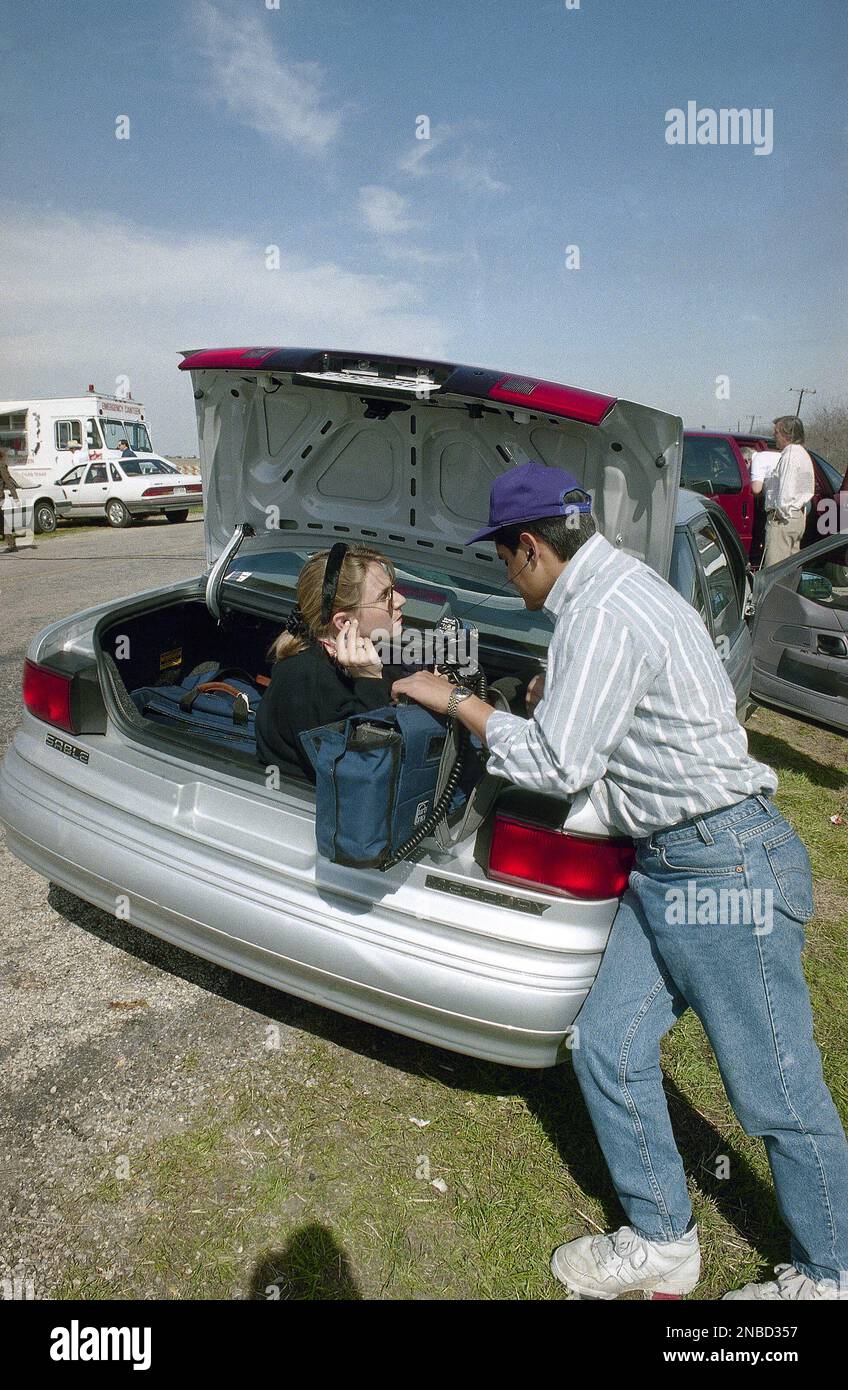 Diana Cosculluela, a reporter with Univision, uses a car trunk as a ...