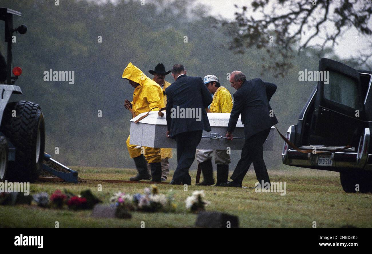 A casket is lowered into a grave as the unclaimed remains of 29 Branch ...