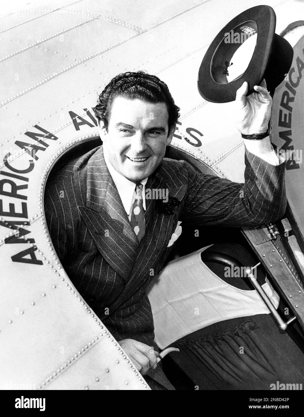 Irish boxer and actor Jack Doyle waving his hat in farewell to Newark ...