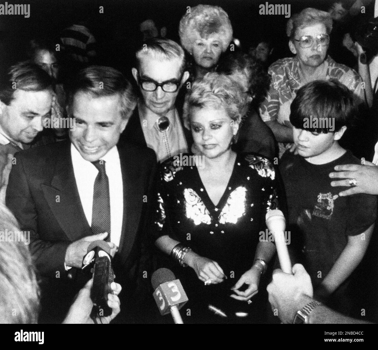 Former PTL chairman Jim Bakker and his wife Tammy talk to reporters as ...