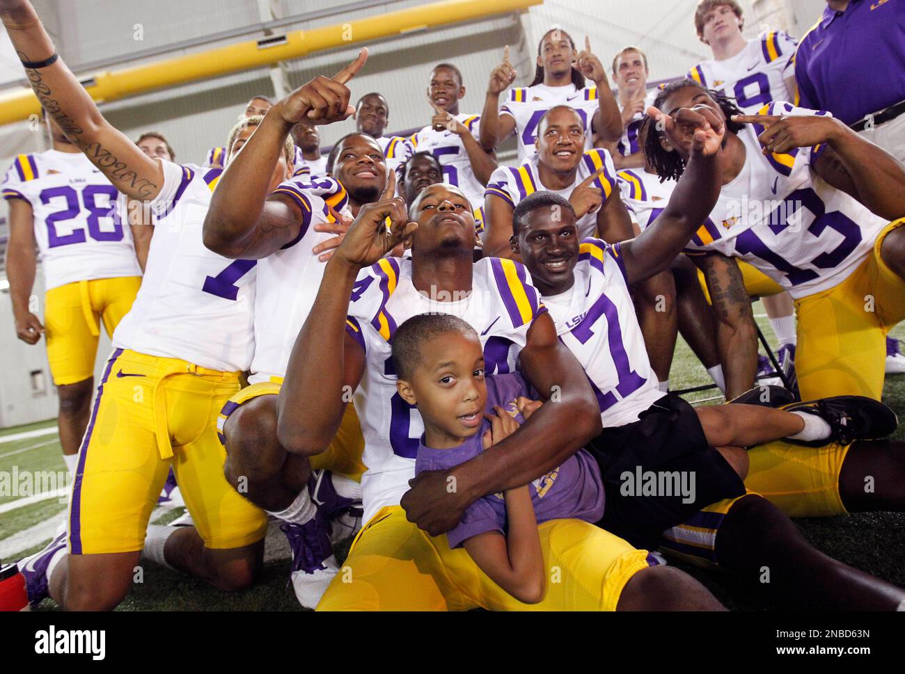 LSU defensive backs pose for a photo with Ron "Deuce" Cooper Jr., son ...