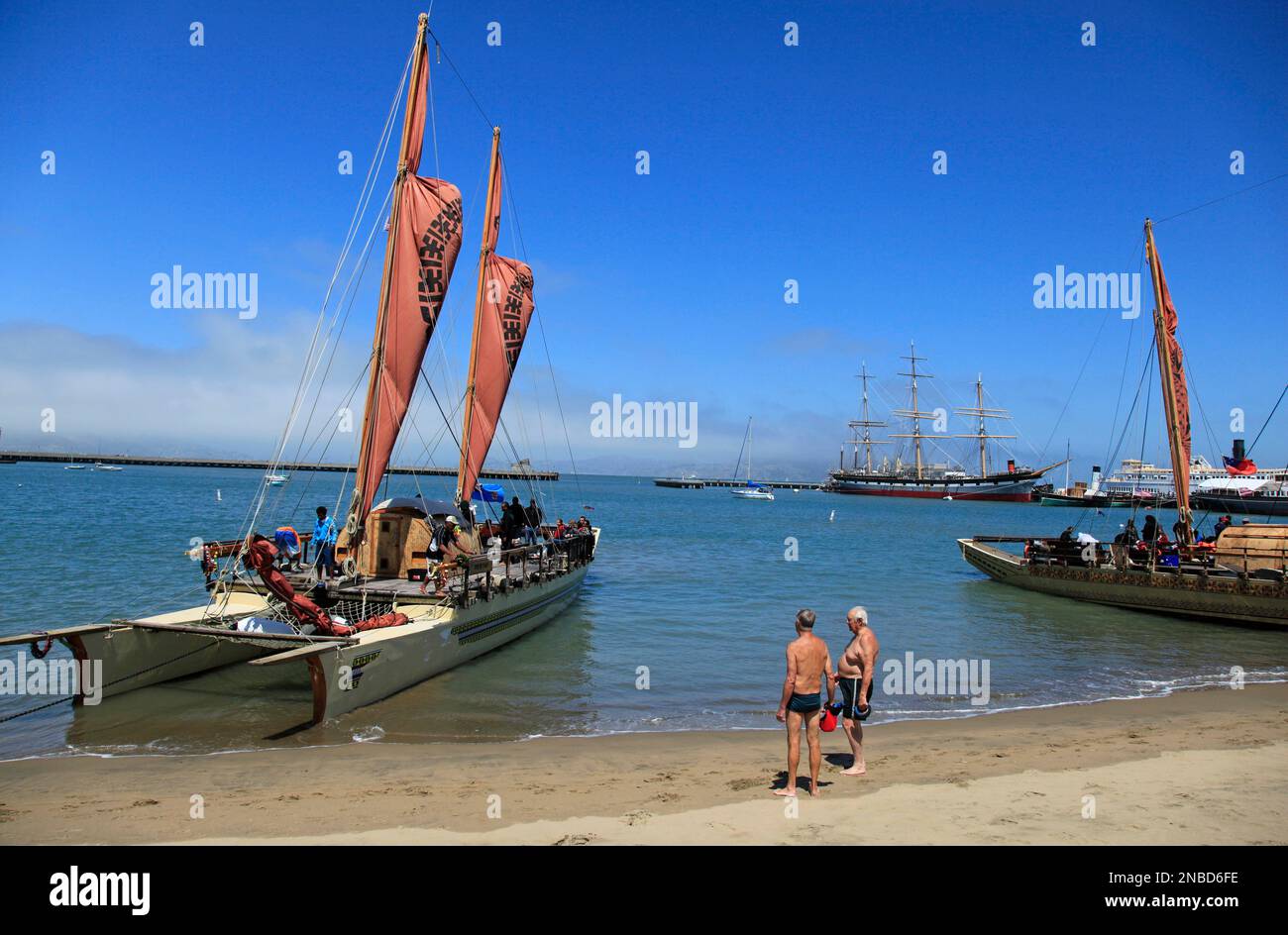 Two swimmers look over a Pacific Voyagers vaka from Fiji tied up on the ...