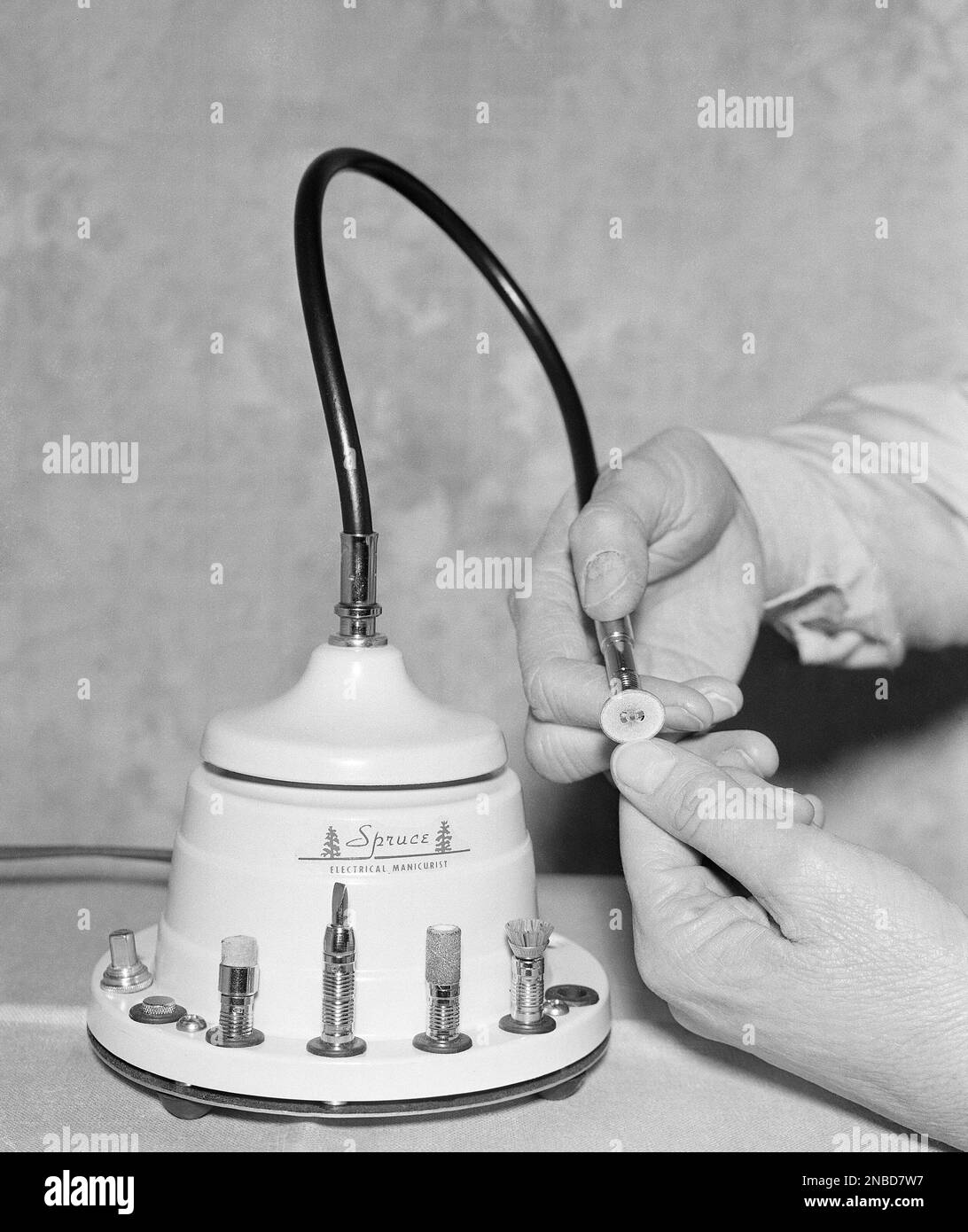 The disc file of a newly invented electric manicure is demonstrated in ...