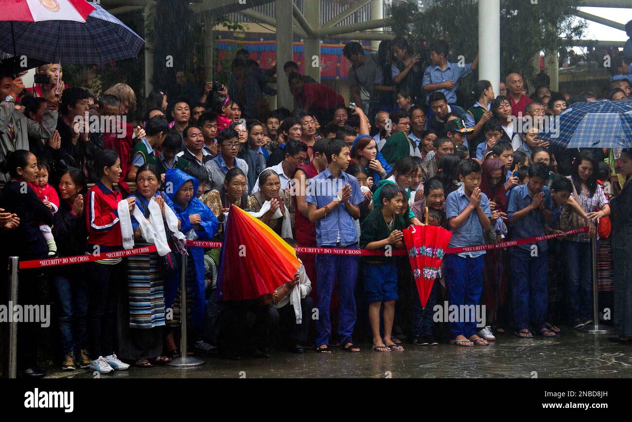 Exile Tibetans carrying traditional scarves called "khatag" wait to ...