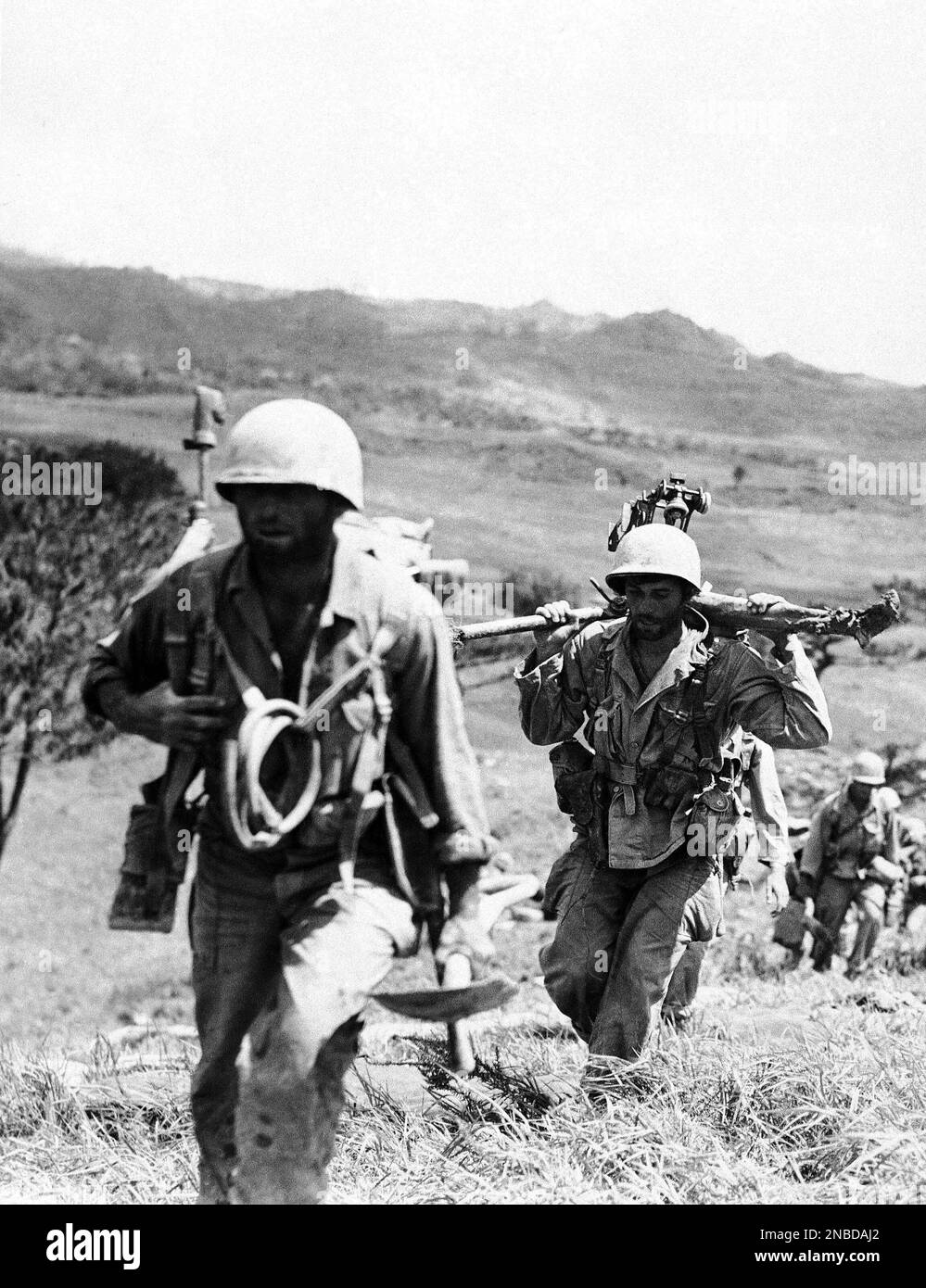 Men of a heavy weapons company carrying light and heavy machine guns up ...