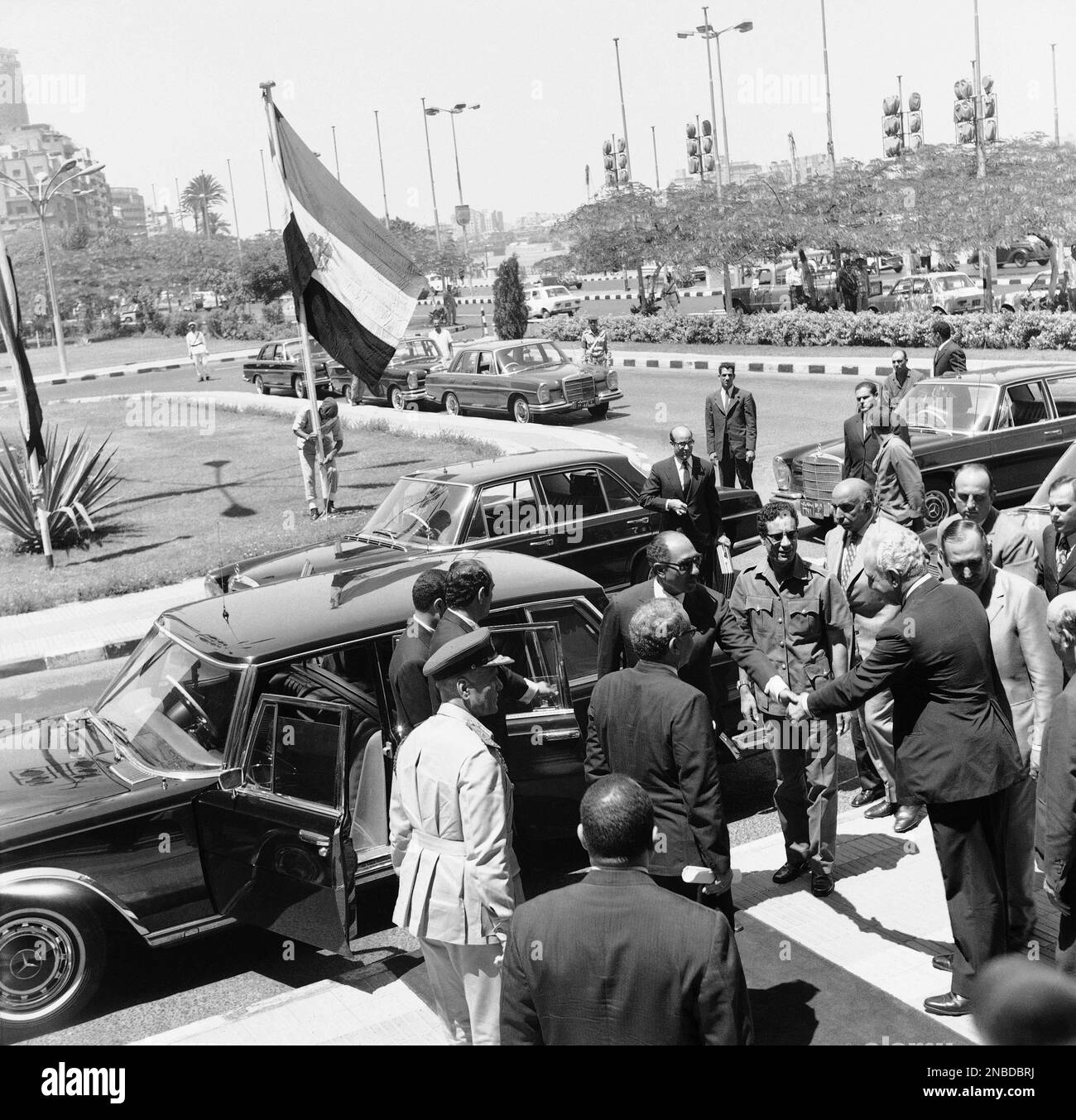 Egyptian President Anwar Sadat shaking hands with an unidentified ASU ...