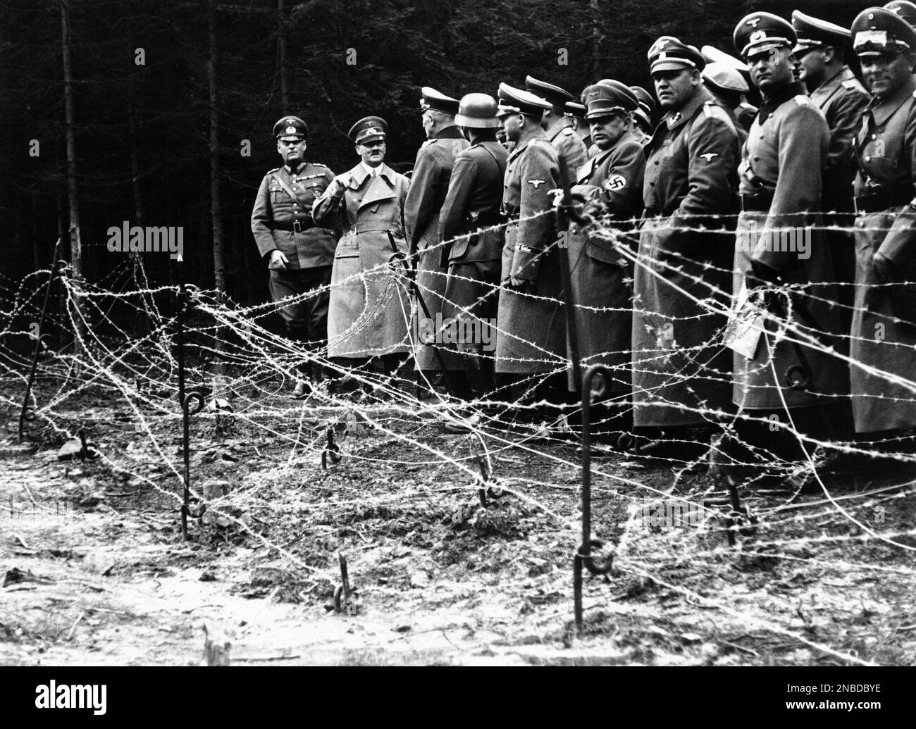 Adolf Hitler, second from left, in front of the barbed wire ...