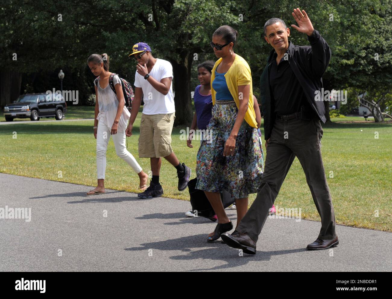 President Barack Obama, right, waves as he walks from Marine One and ...