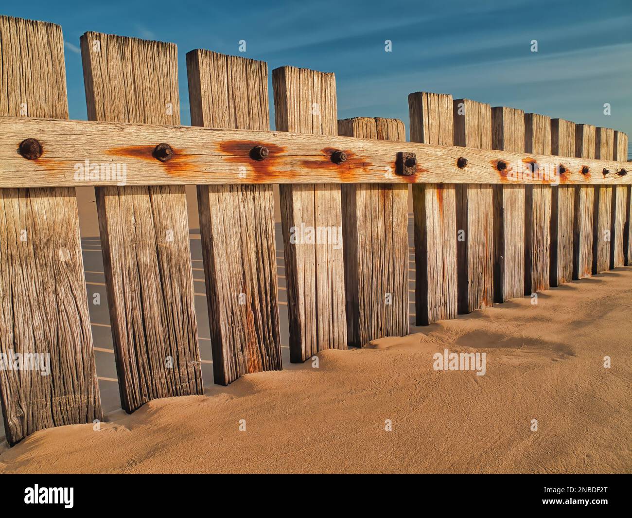 Weather beaten wooden fence on sandy beach Stock Photo - Alamy