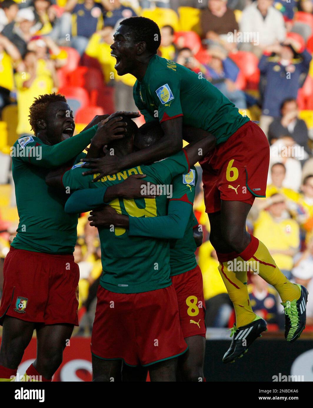 Cameroon's Emmanuel Mbongo, 8, is congratulated by Nguesi, right and ...