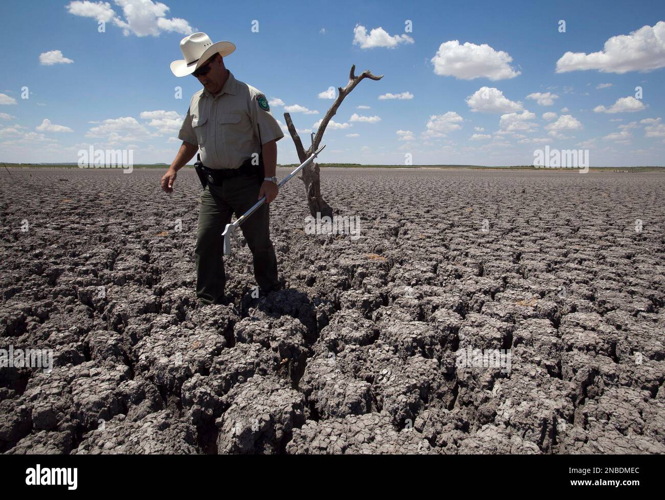 Texas State Park police officer Thomas Bigham walks along the dried bed ...