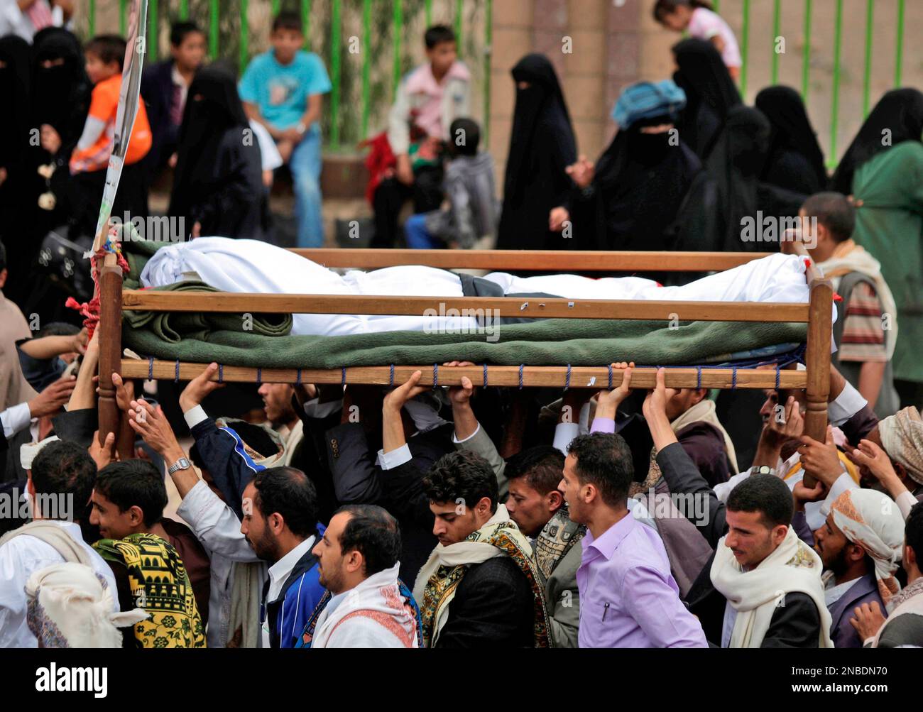 Demonstrators carry the body of Muneer Mohammed Sabiq al-Sayagih before traditional Friday ...