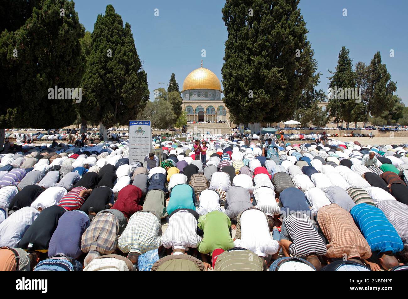 Thousands of Muslim worshipers pray at the Al-Aqsa Mosque compound on ...