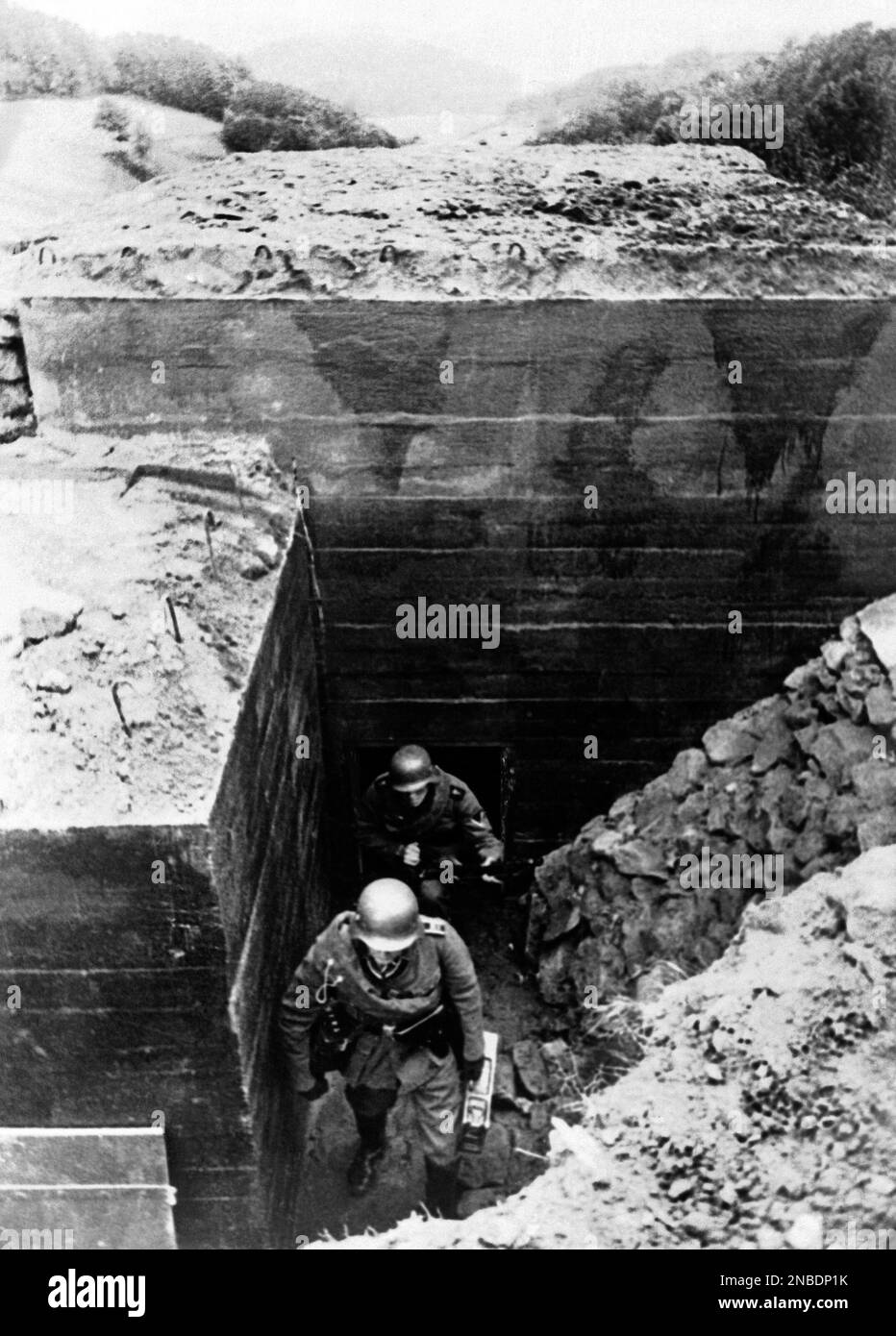 German machine gunners leaving the thick concrete fortification on the ...