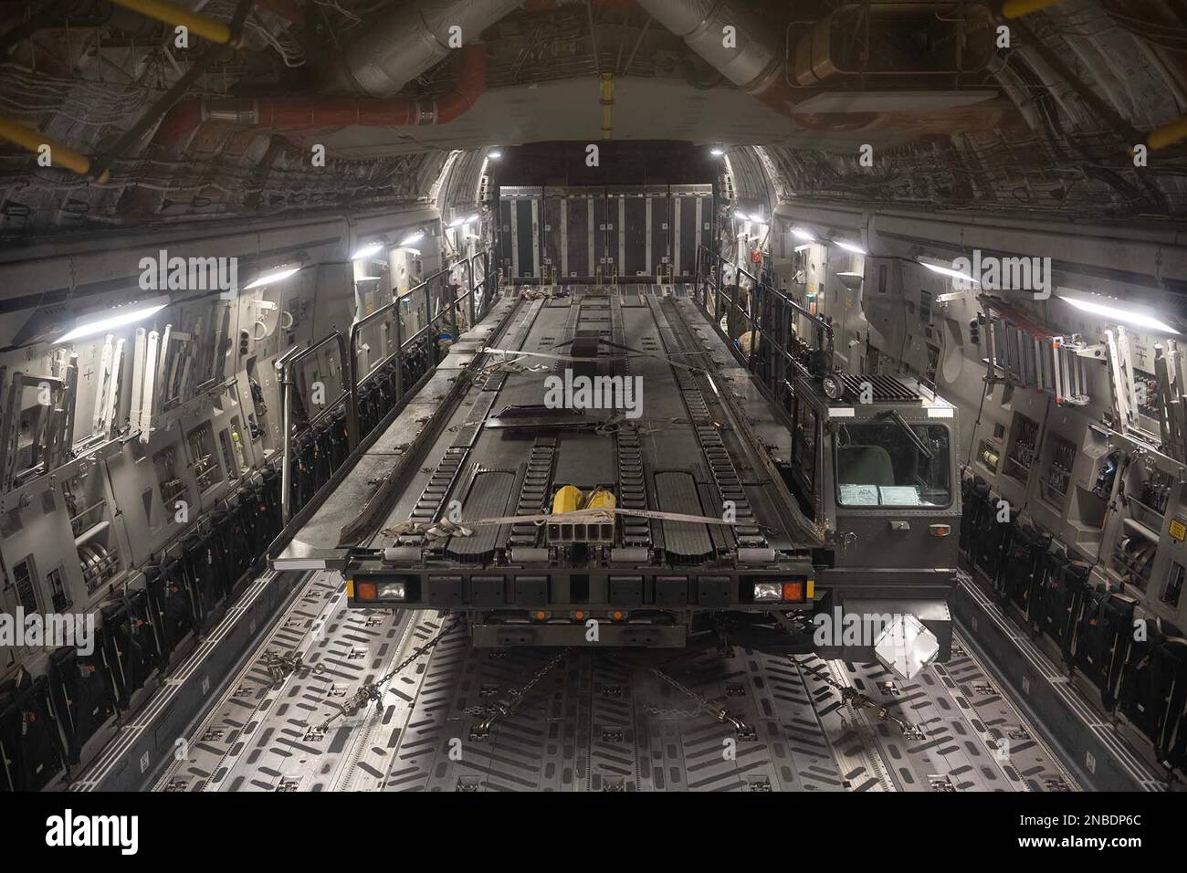 U.S. Airmen with the 60th Aerial Port Squadron chain a 60K-Loader to ...