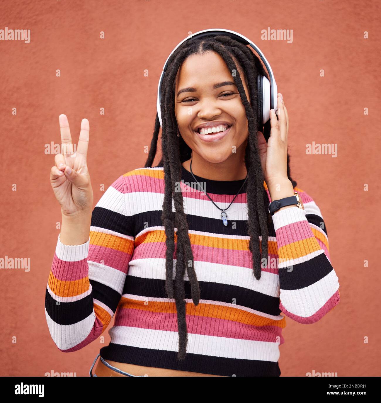 Portrait, headphones and black woman with peace sign isolated on orange ...