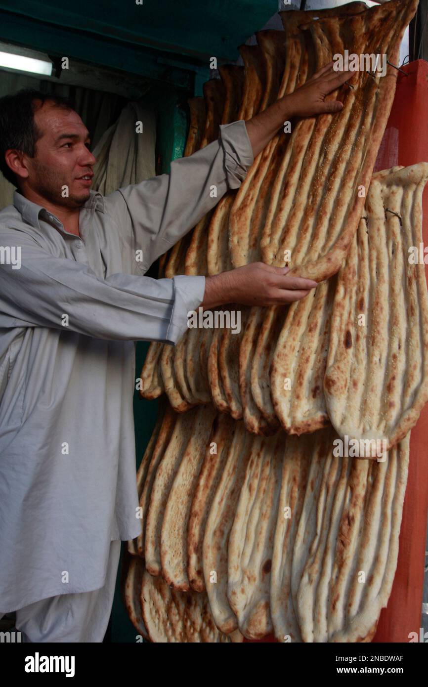 A Pakistani vendor arranges breads for customers before Iftar, a break ...