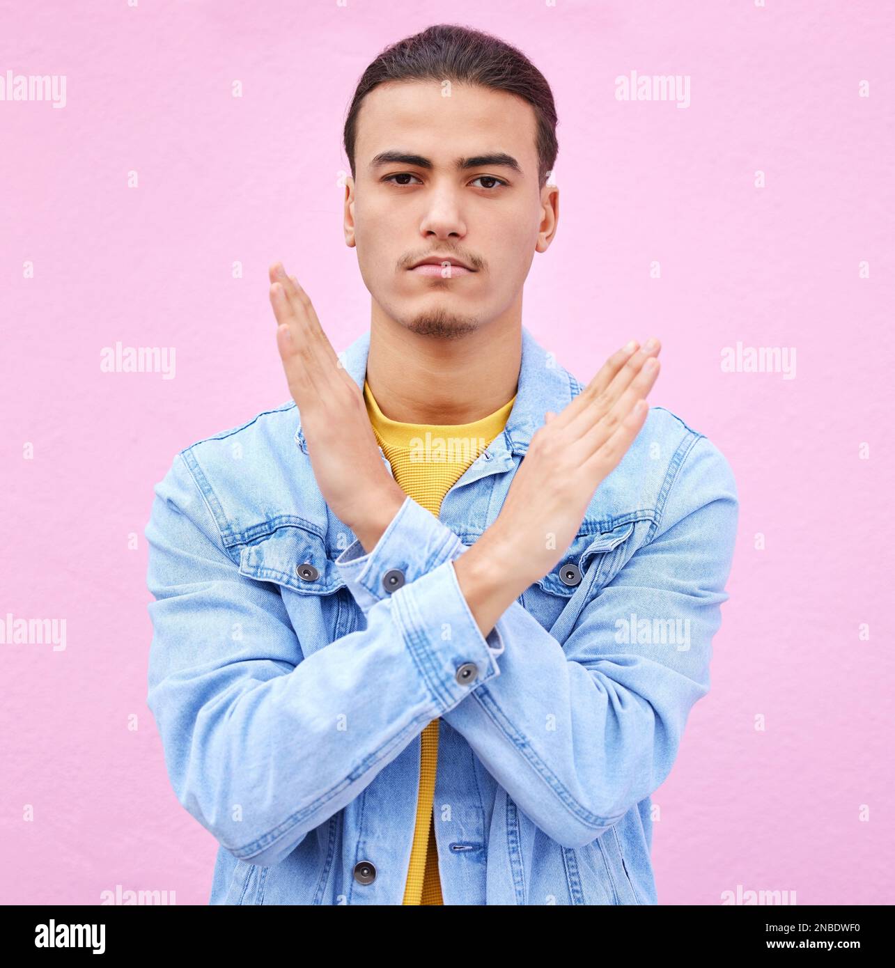 No, stop and portrait of a man with hands as a sign isolated on a pink ...