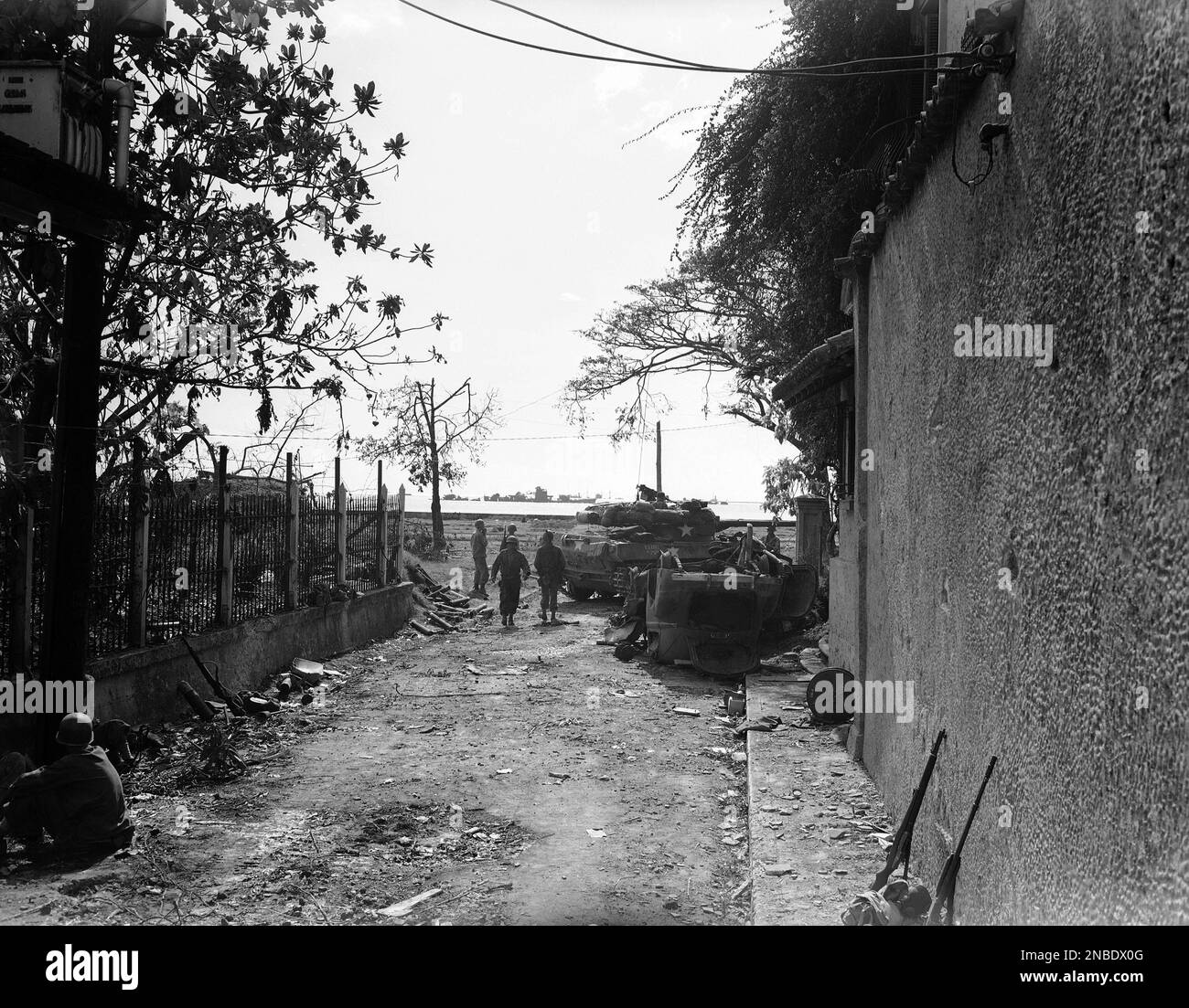 A tank destroyer fires from the protection of a building at the U.S ...