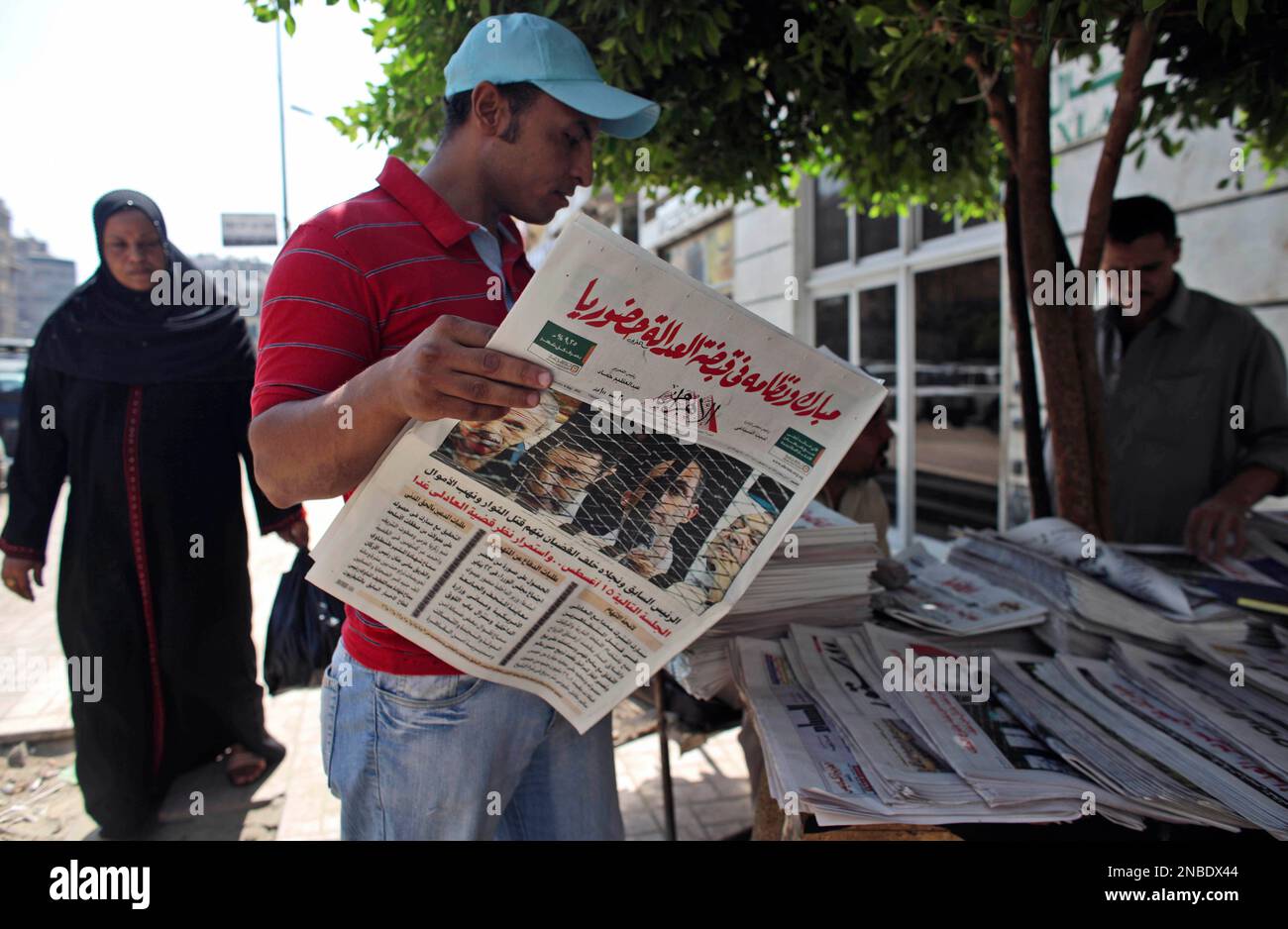 An Egyptian man reads a newspaper in downtown Cairo, Egypt, Thursday ...