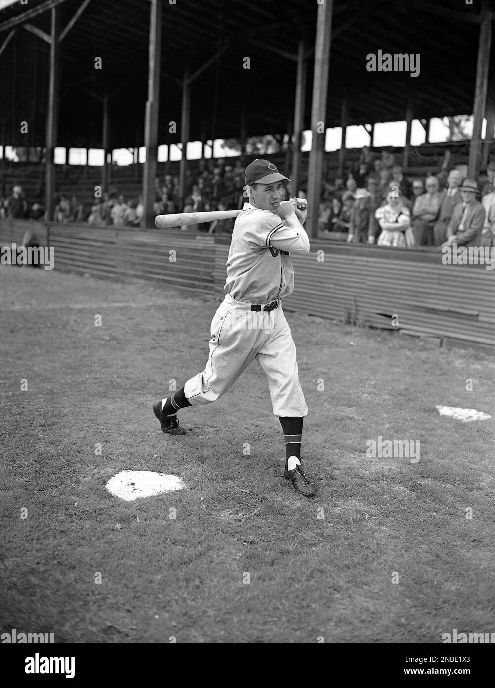 Bob Feller, Cleveland Indians ace hurler, taking a swing at the ball ...
