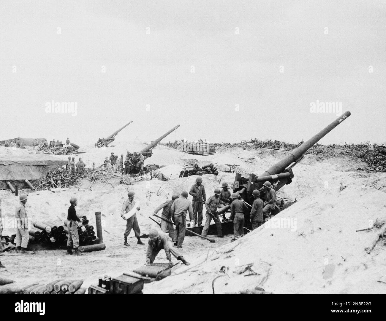 Battery of “Long Toms,” 155mm guns are being set up on tiny island four ...