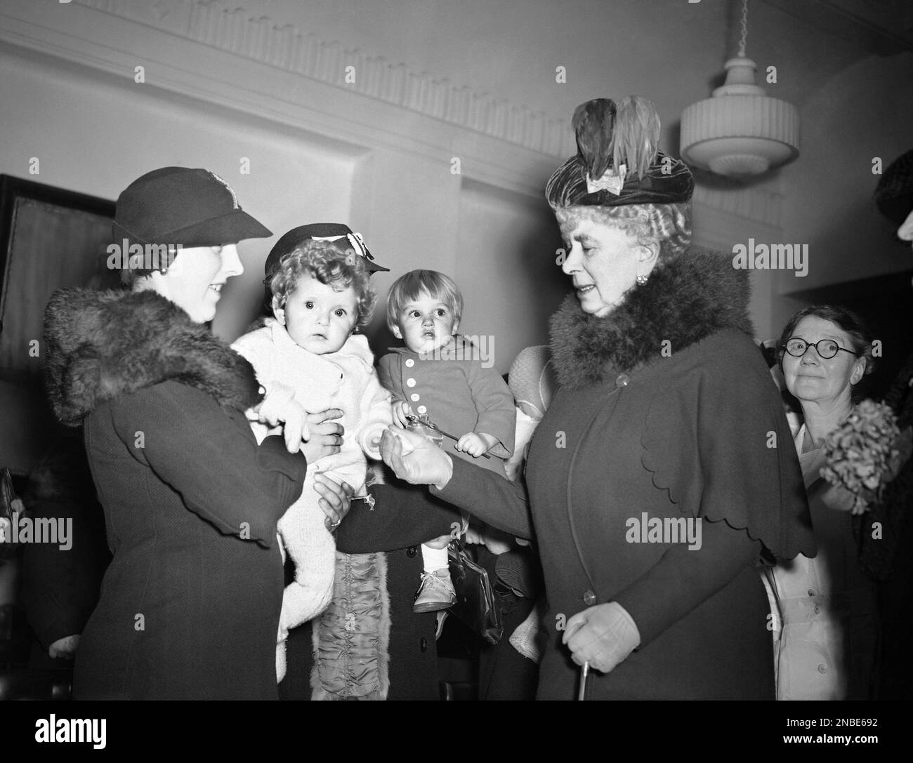 Britain's Queen Mary holds the hand of 10 month old Eva Markham during ...