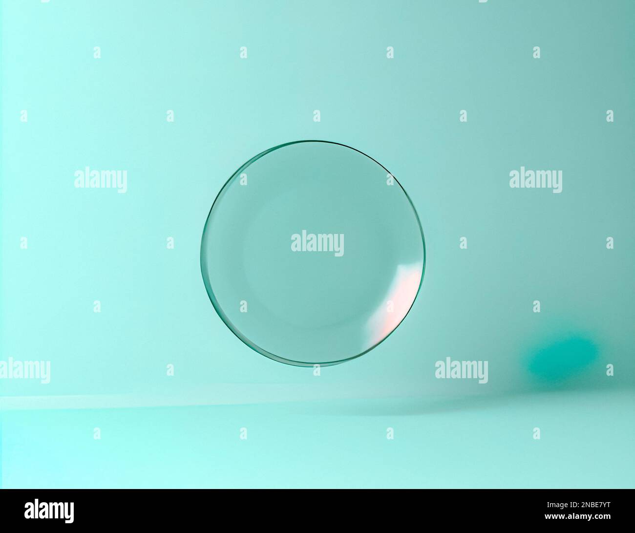 A 3D digital illustration of a glass disk on aqua background Stock ...