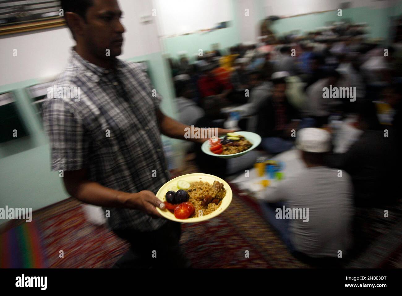 Food is distributed to Muslims breaking the fast on the evening of the ...