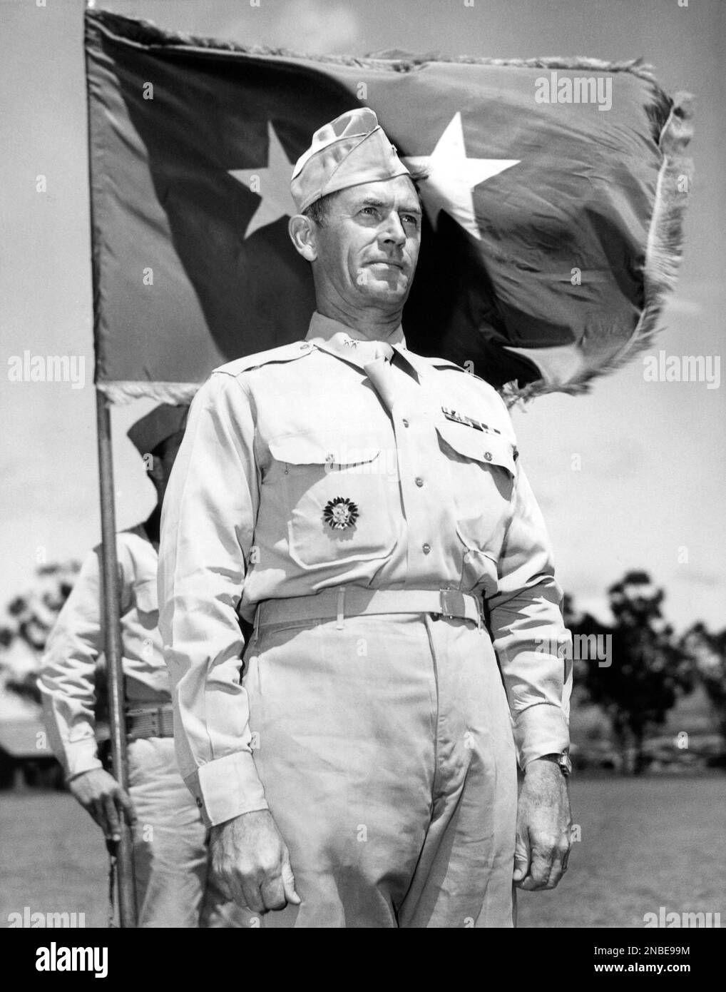 Army Maj. Gen. Ralph Smith stands in front of his flag during a review ...
