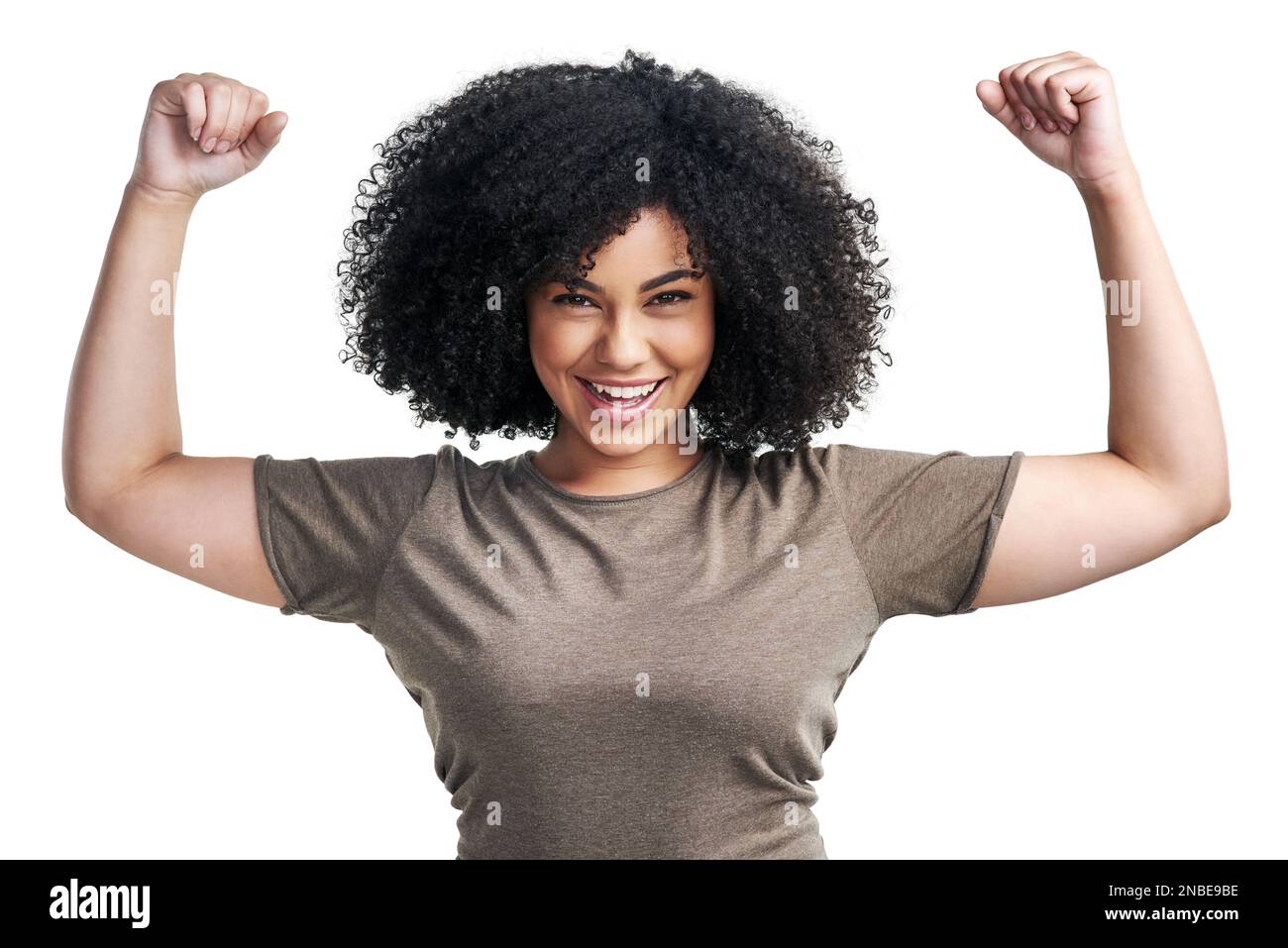 Stand back and watch me grow. Studio shot of young woman flexing her ...