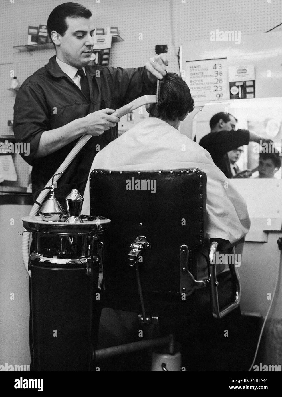 Barber Raymond Burbery demonstrates the special vacuum cleaner he is ...