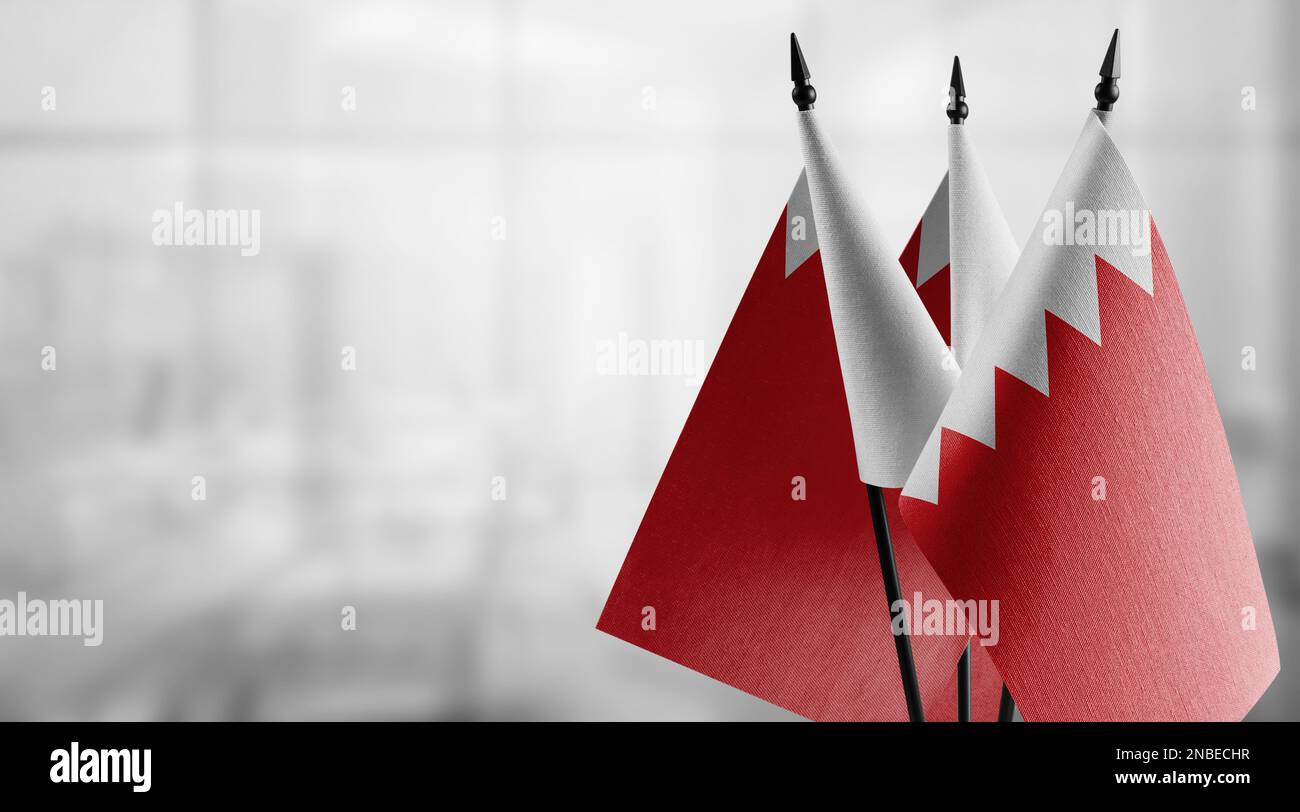 Small flags of the Bahrain on an abstract blurry background Stock Photo ...