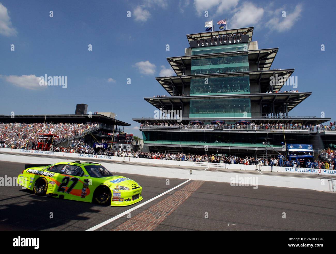 Paul Menard crosses the finish line to win the NASCAR Brickyard 400 ...