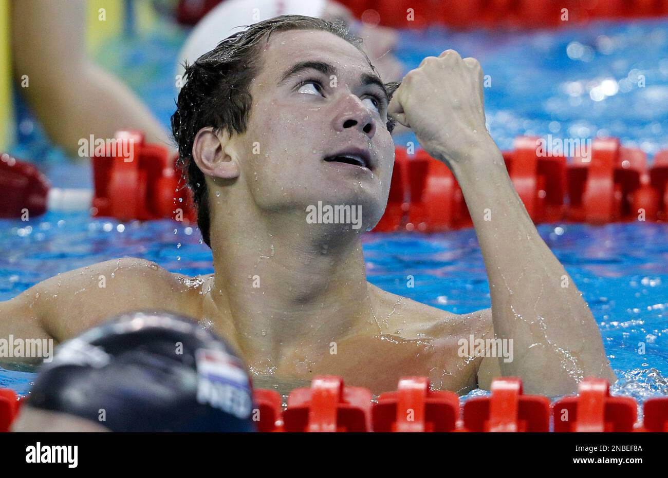 The U.S. team's Nathan Adrian celebrates after finishing his race to ...