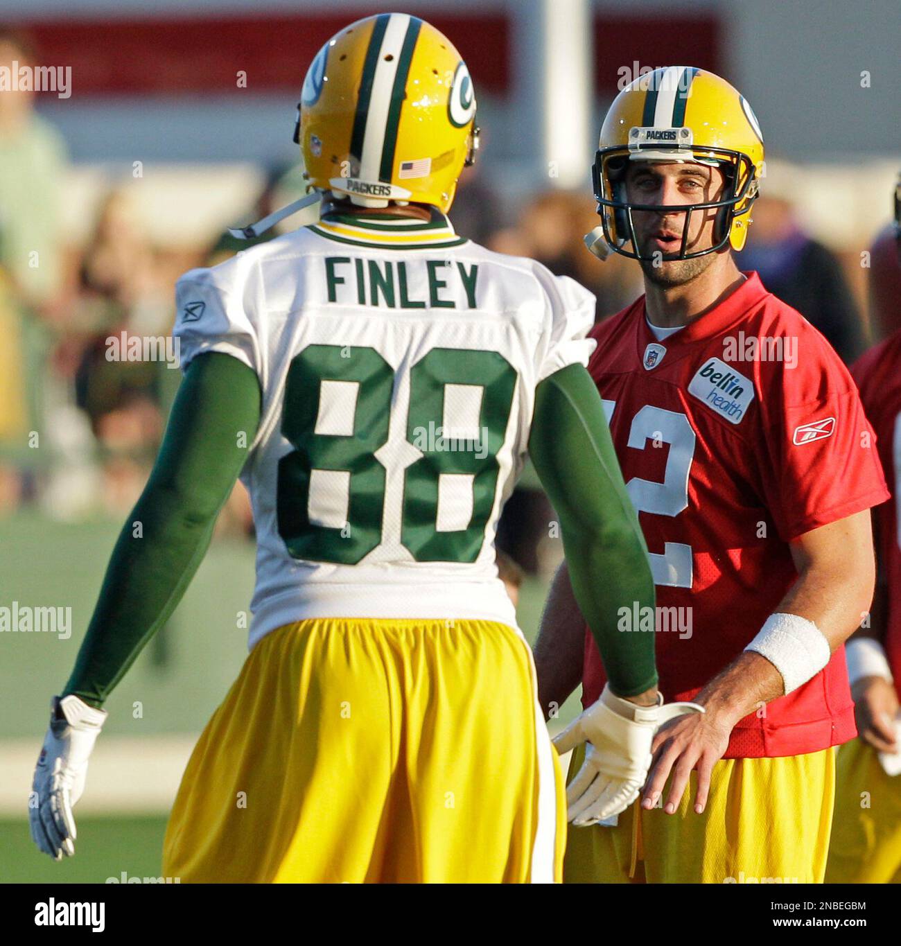 Green Bay Packers' Aaron Rodgers talks to Jermichael Finley during NFL ...
