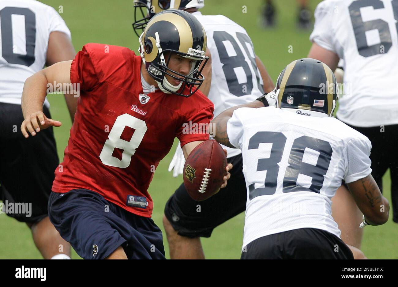 St. Louis Rams quarterback Sam Bradford, left, fakes a hand off to ...