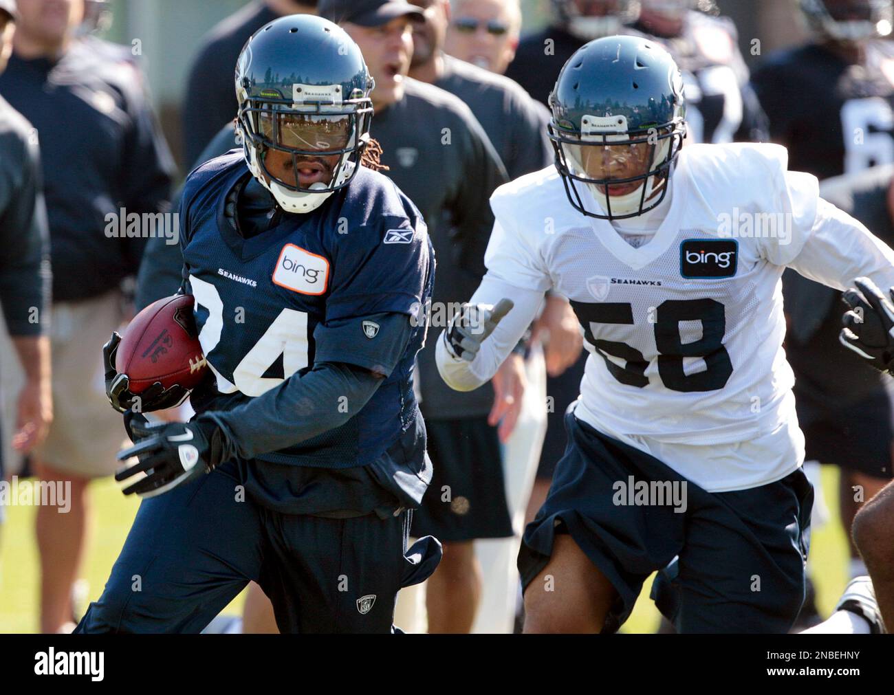 Seattle Seahawks' Marshawn Lynch, left, gets past Dexter Davis at NFL ...