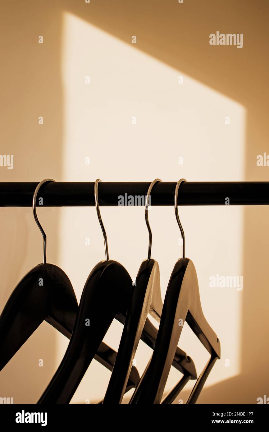Empty hangers on the rack in a warm sunset light Stock Photo - Alamy