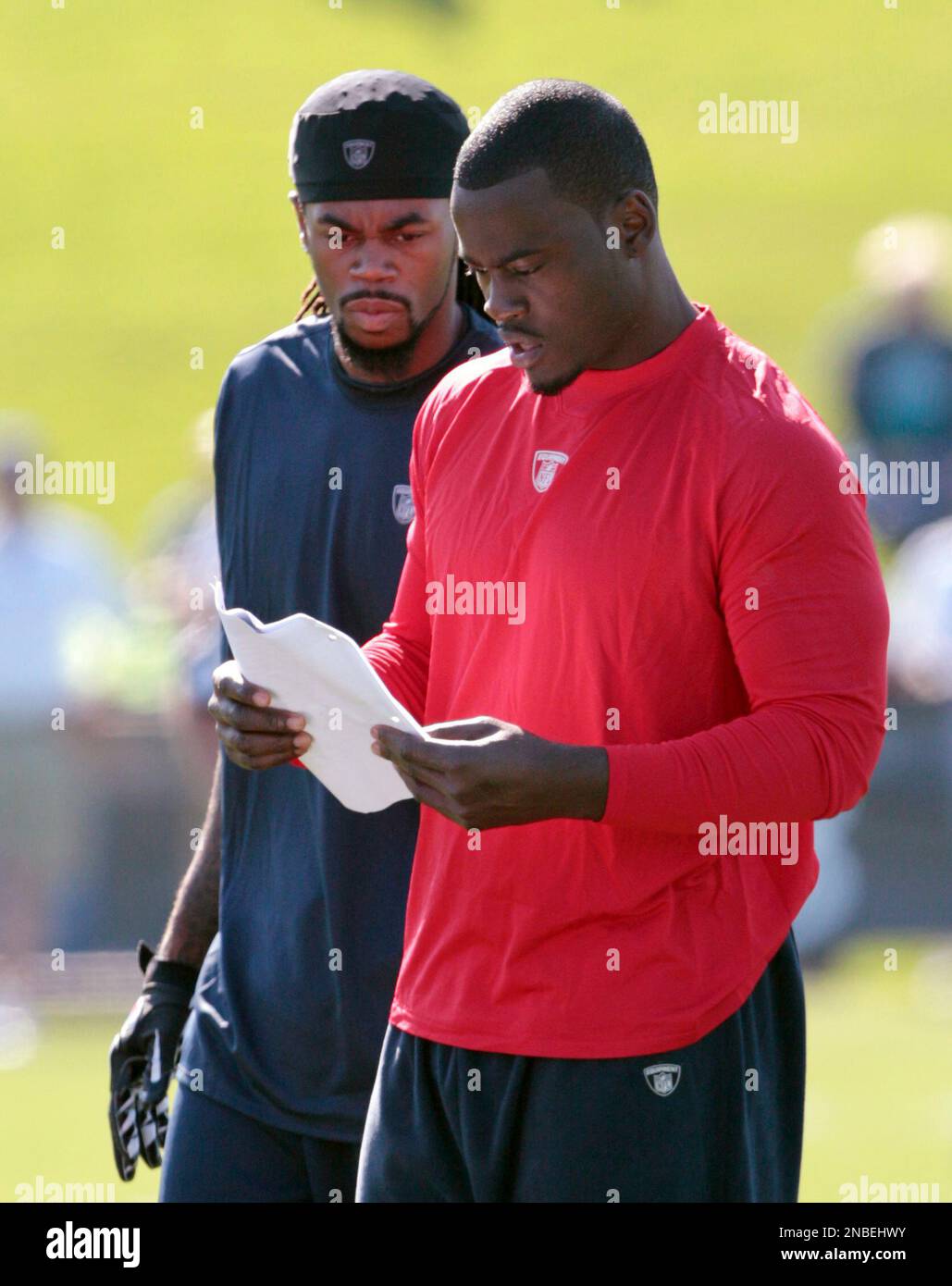 Seattle Seahawks' Tarvaris Jackson, right, and Sidney Rice look over ...