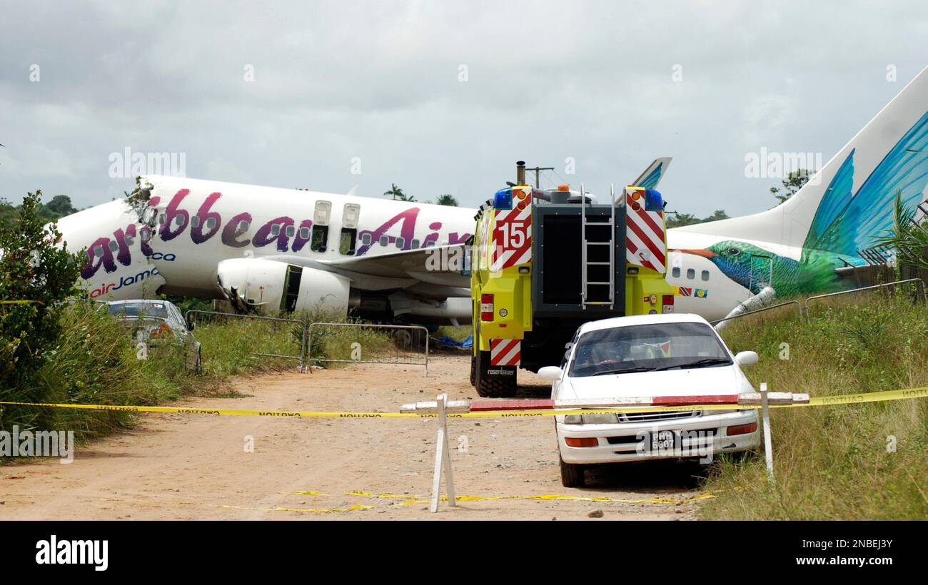 The broken fuselage of a Caribbean Airlines' Boeing 737-800 is seen ...