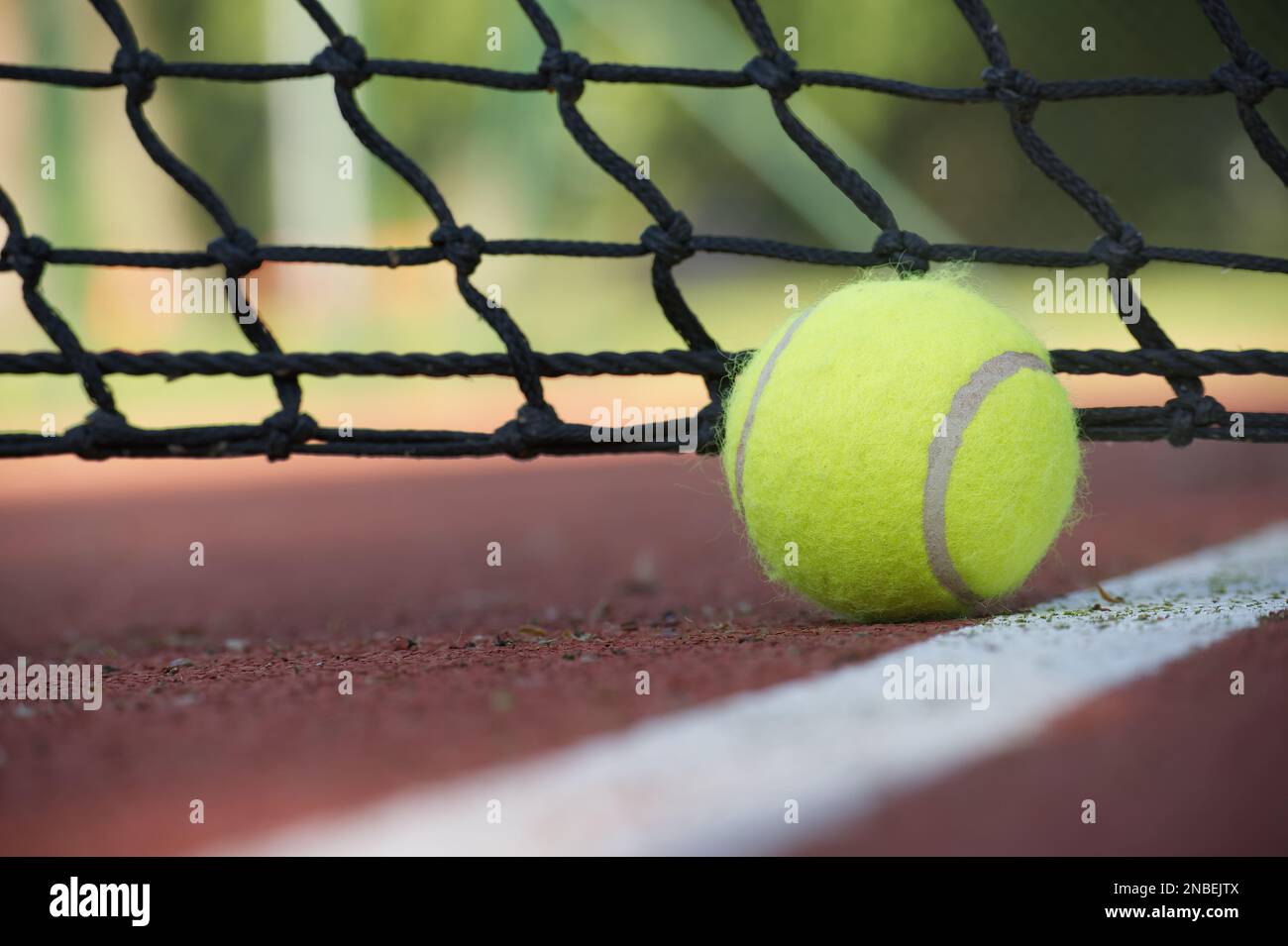 Tennis ball in the net. Ball hitting the tennis net, tennis scene with ...