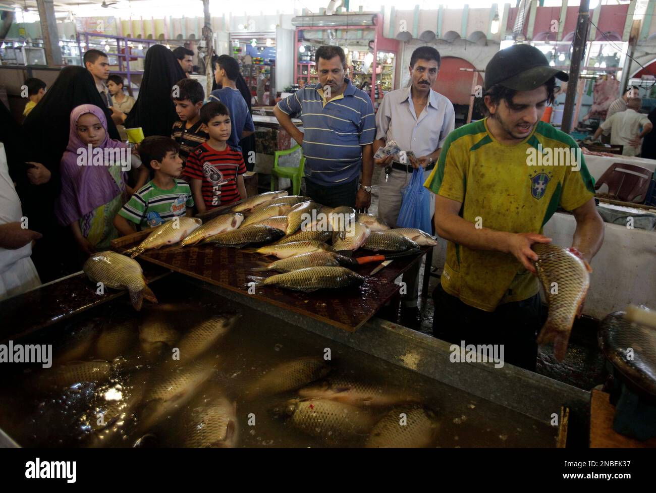 Street vendors sell fresh fish at an open air market in east Baghdad's ...