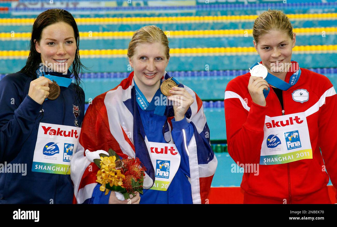 Britain's Rebecca Adlington, center, shows her gold medal with Denmark ...