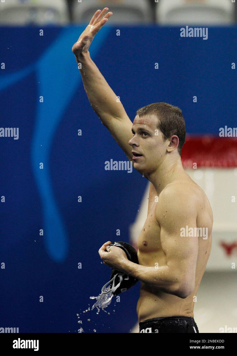 Brazil's Cesar Cielo waves as he leaves the pool after winning the gold ...