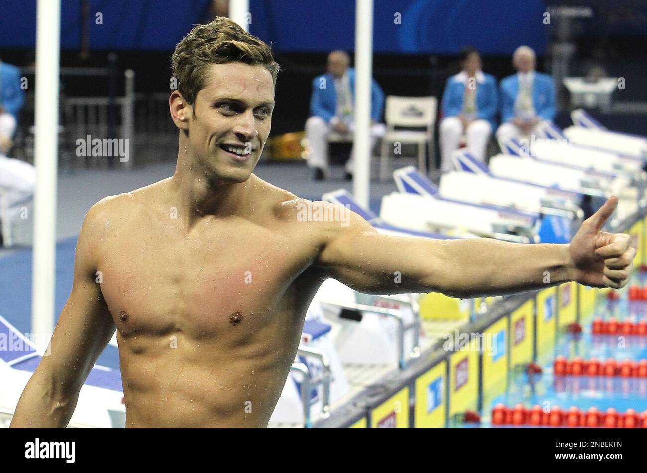 Italy's Luca Dotto gives a thumbs-up as he leaves the pool after ...