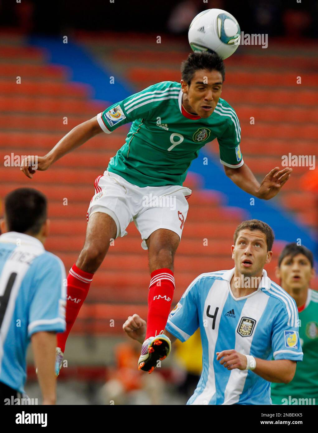 Mexico's Taufic Guarch heads the ball as Argentina's Adrian Martinez ...