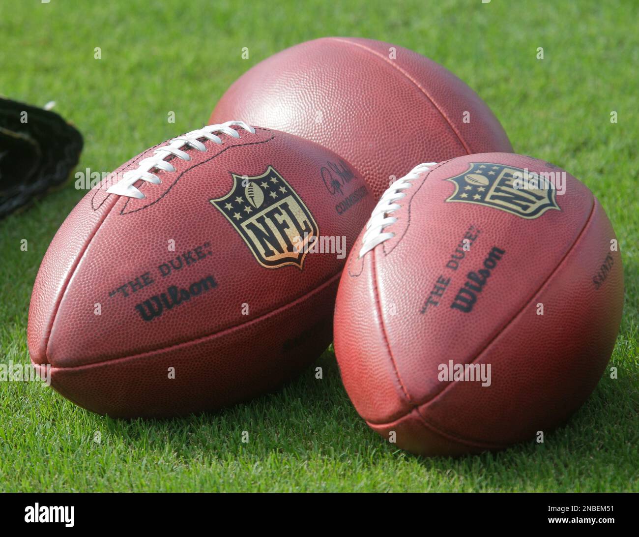 Footballs on the turf at the team's NFL football training facility ...