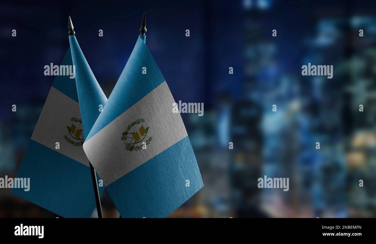 Small flags of the Guatemala on an abstract blurry background Stock ...
